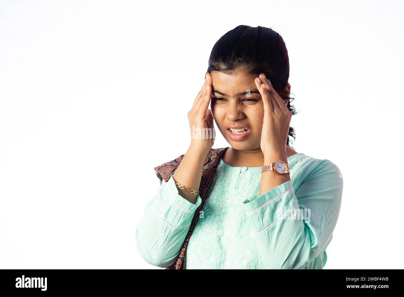 An Indian woman holding her head in pain showing painful expression on ...