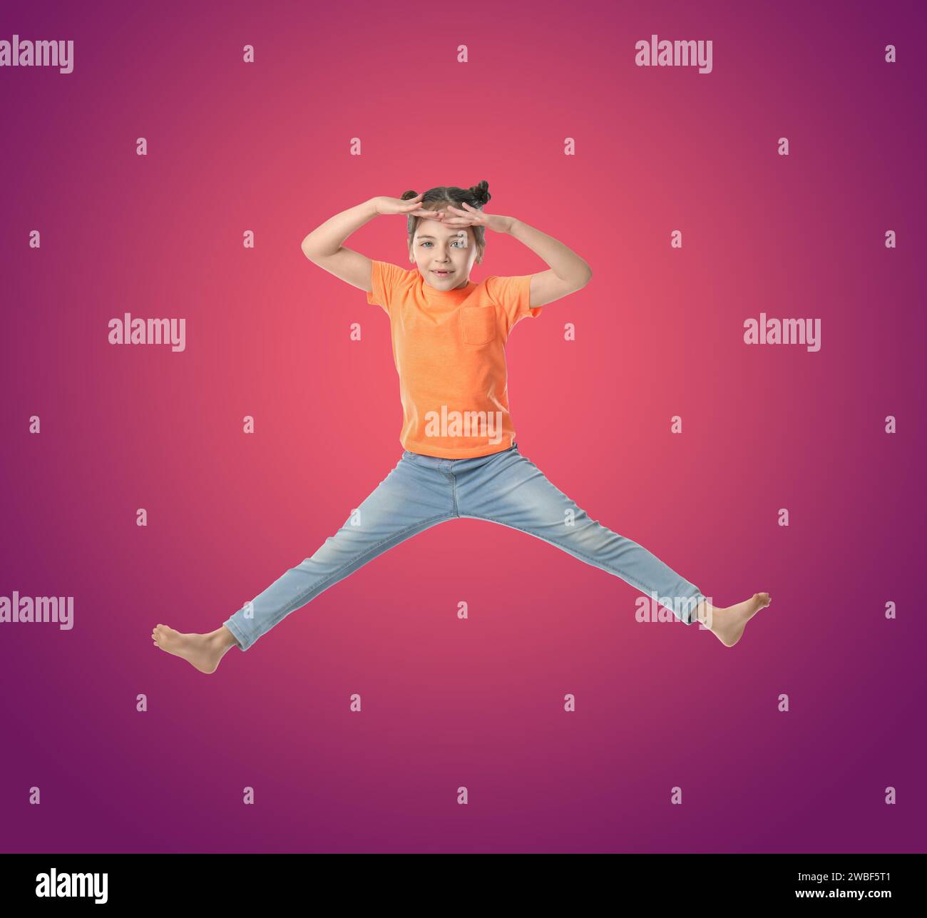 Happy cute girl jumping on color gradient background Stock Photo - Alamy
