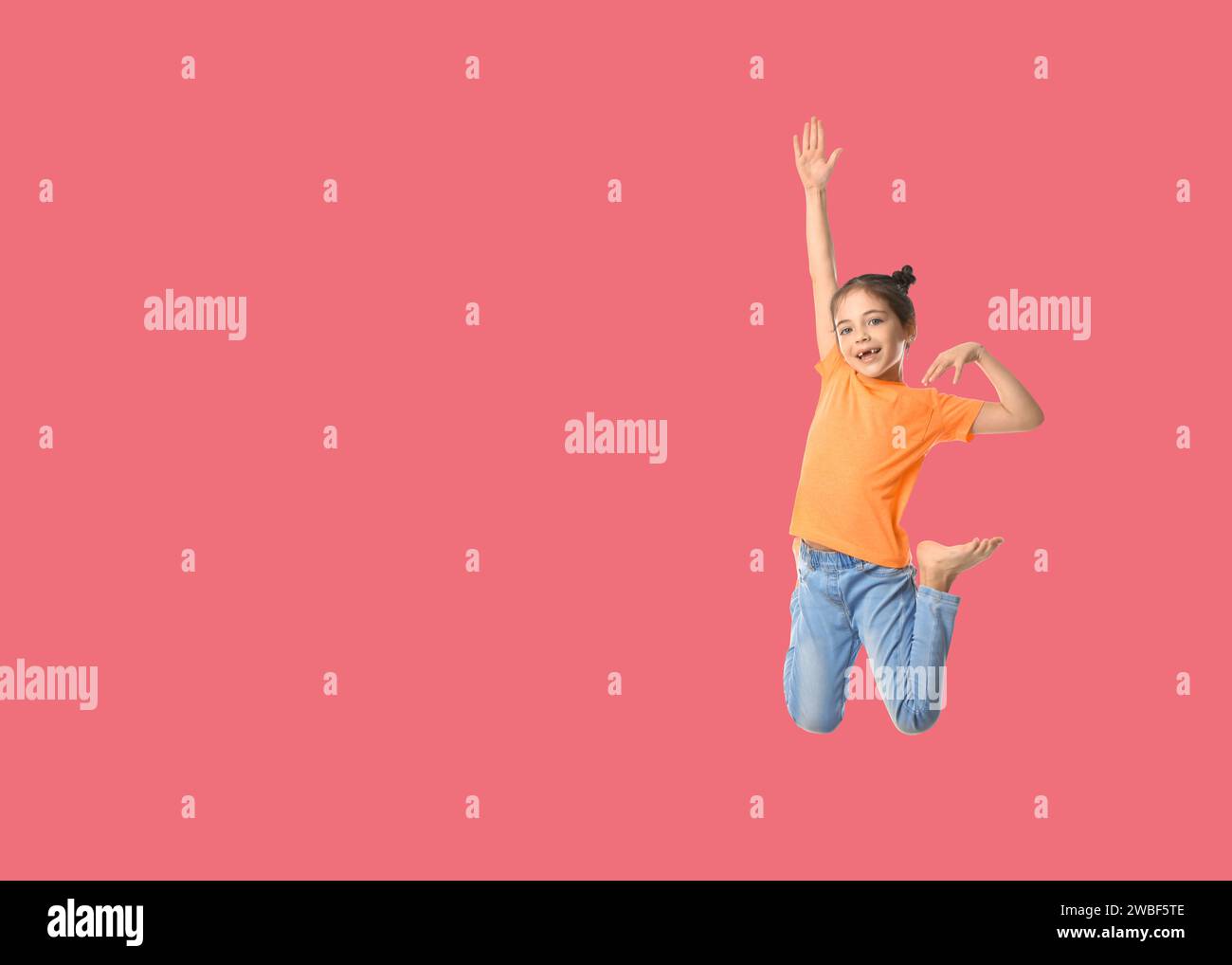 Cute girl jumping on pale red background, space for text Stock Photo ...