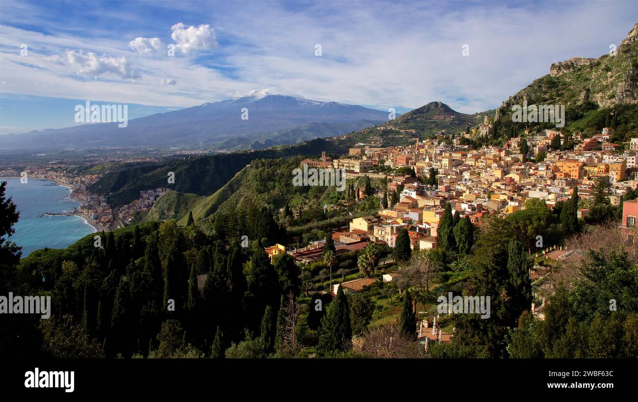 Mount Etna, panoramic view of a coastal town with mountains in the ...