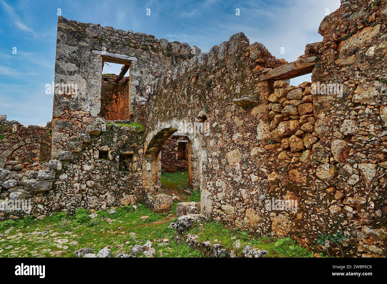 Historic ruins with window openings and a vault, surrounded by green ...