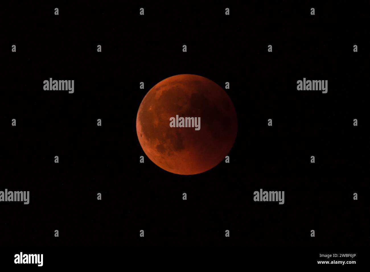 A total lunar eclipse with a reddish moon against a dark sky, Haan ...
