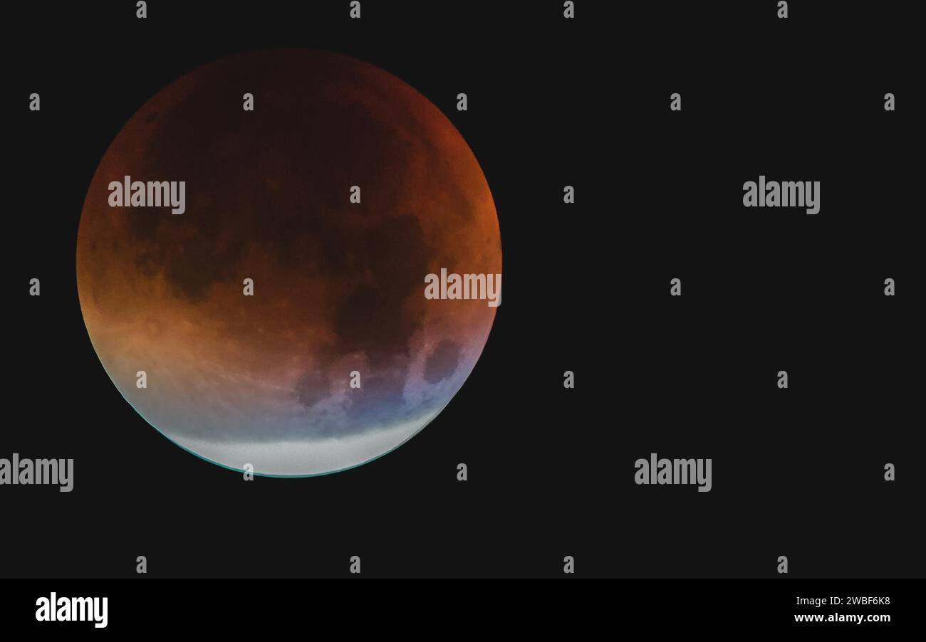 A moon with visible orange and blue tones during a partial lunar ...