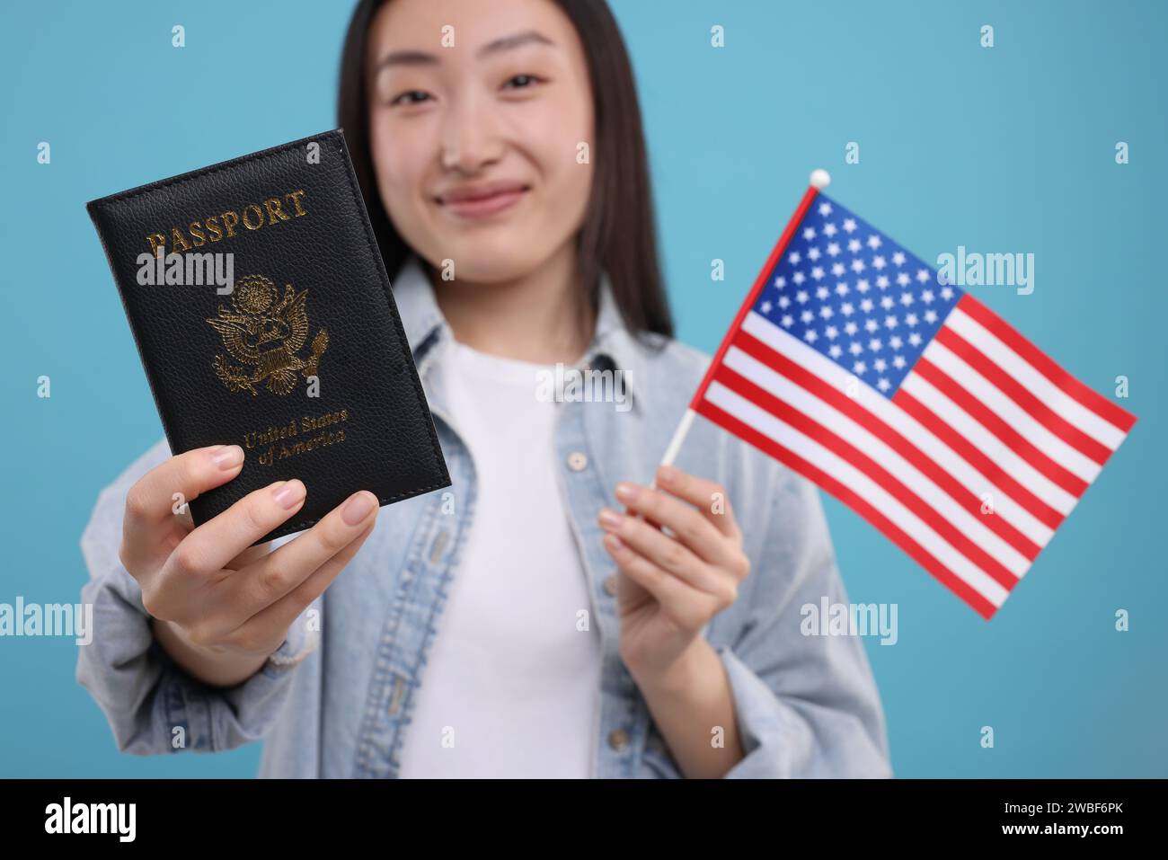 Immigration to United States of America. Woman with passport and flag ...