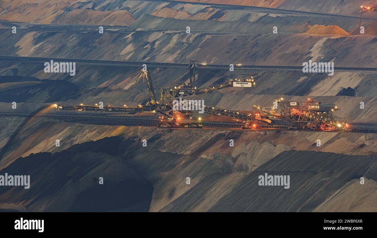 Open-cast mine with a bucket wheel excavator in warm evening light ...