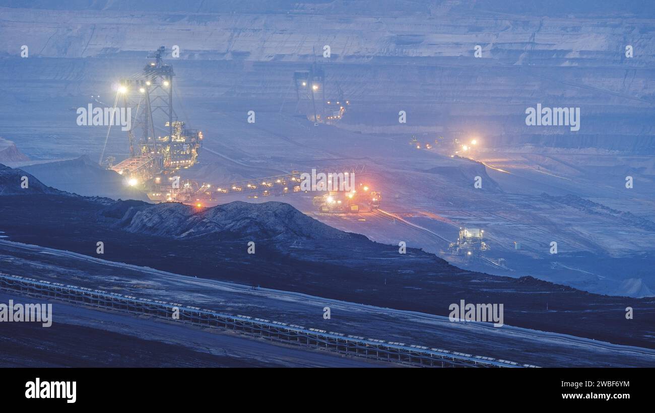 Illuminated open-cast mine at night with cool colour nuances, open-cast ...