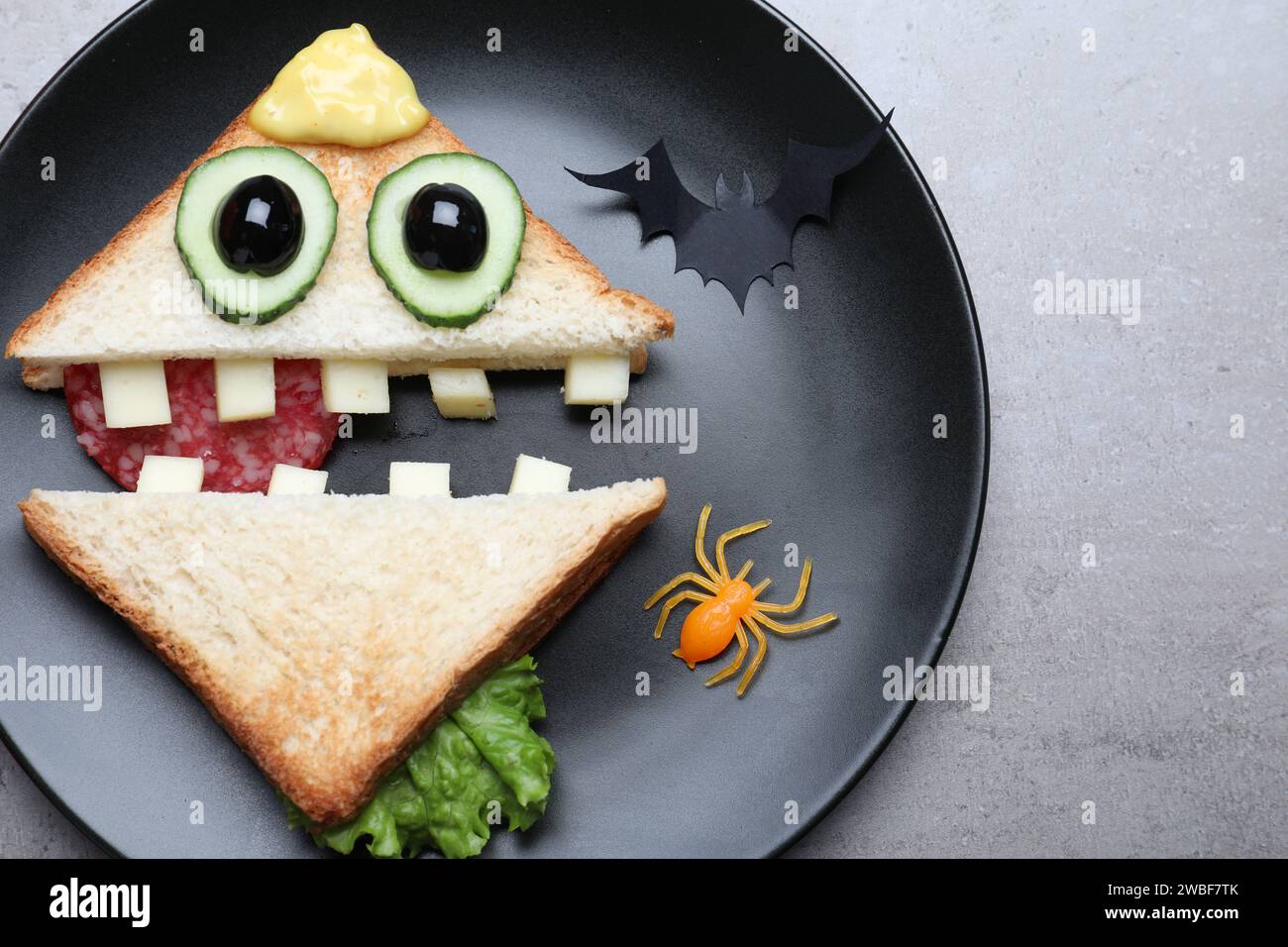 Cute monster sandwich served on grey table, top view. Halloween party ...
