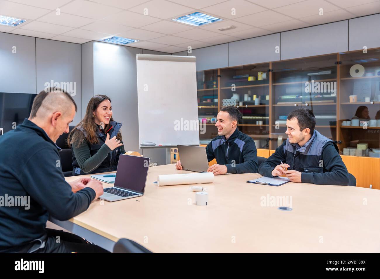 Group of engineers talking during a meeting in a fabric sitting ...