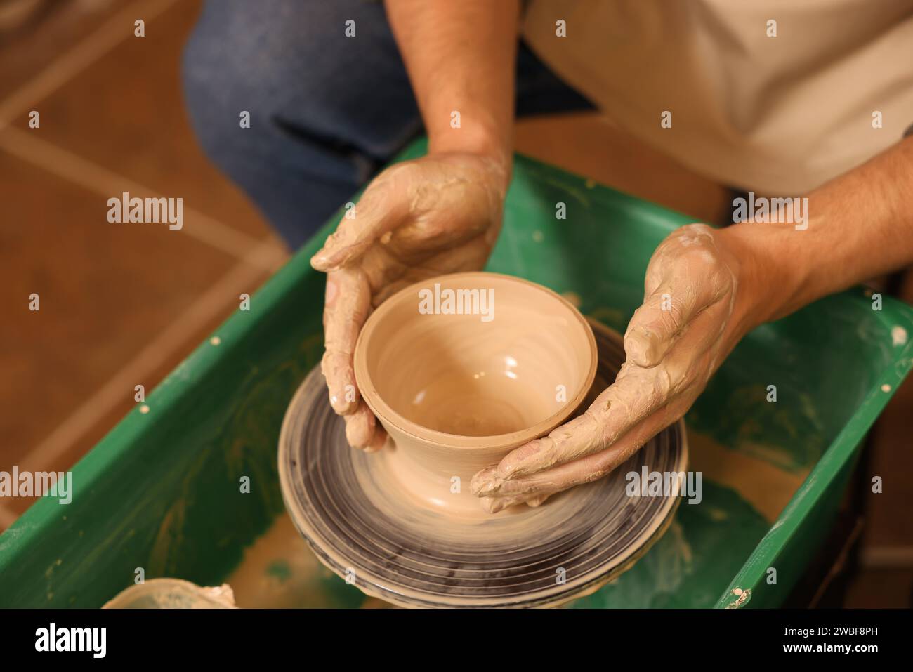 Clay crafting. Man making bowl on potter's wheel, closeup Stock Photo ...