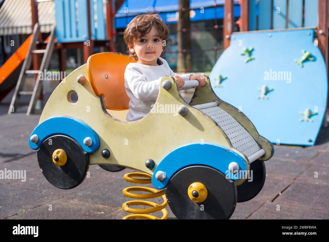 A cute little girl playing in a playground with shape of a car Stock ...