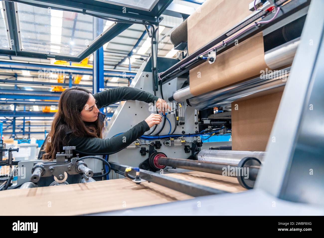 Side view with copy space of a Engineer working on a machine in a cnc ...