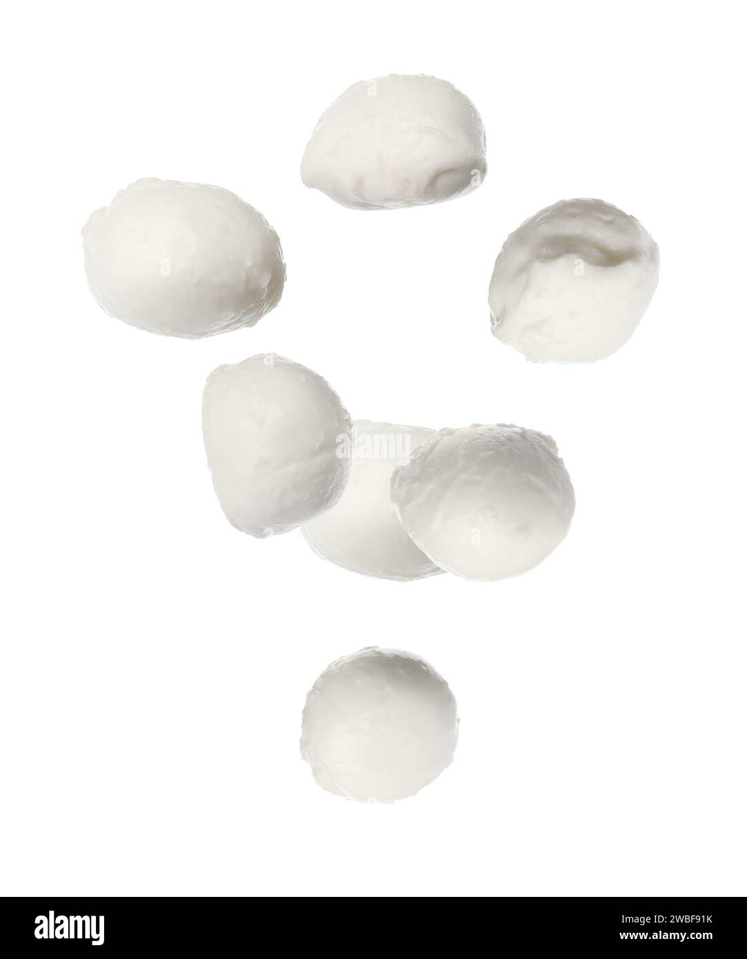Fresh mozzarella balls falling on white background Stock Photo - Alamy