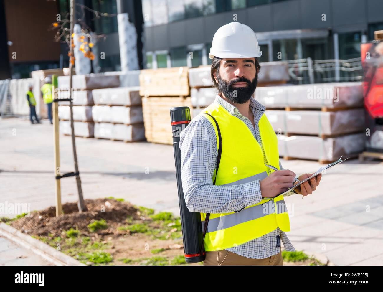 Engineer with an amputee leg working on site in the street next to a ...
