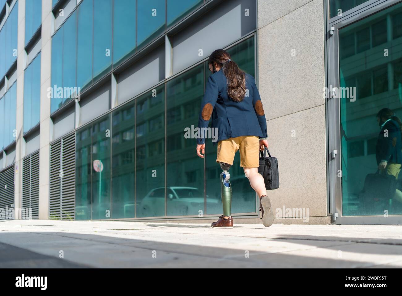 Rear view photo with copy space of a businessman with amputee leg ...