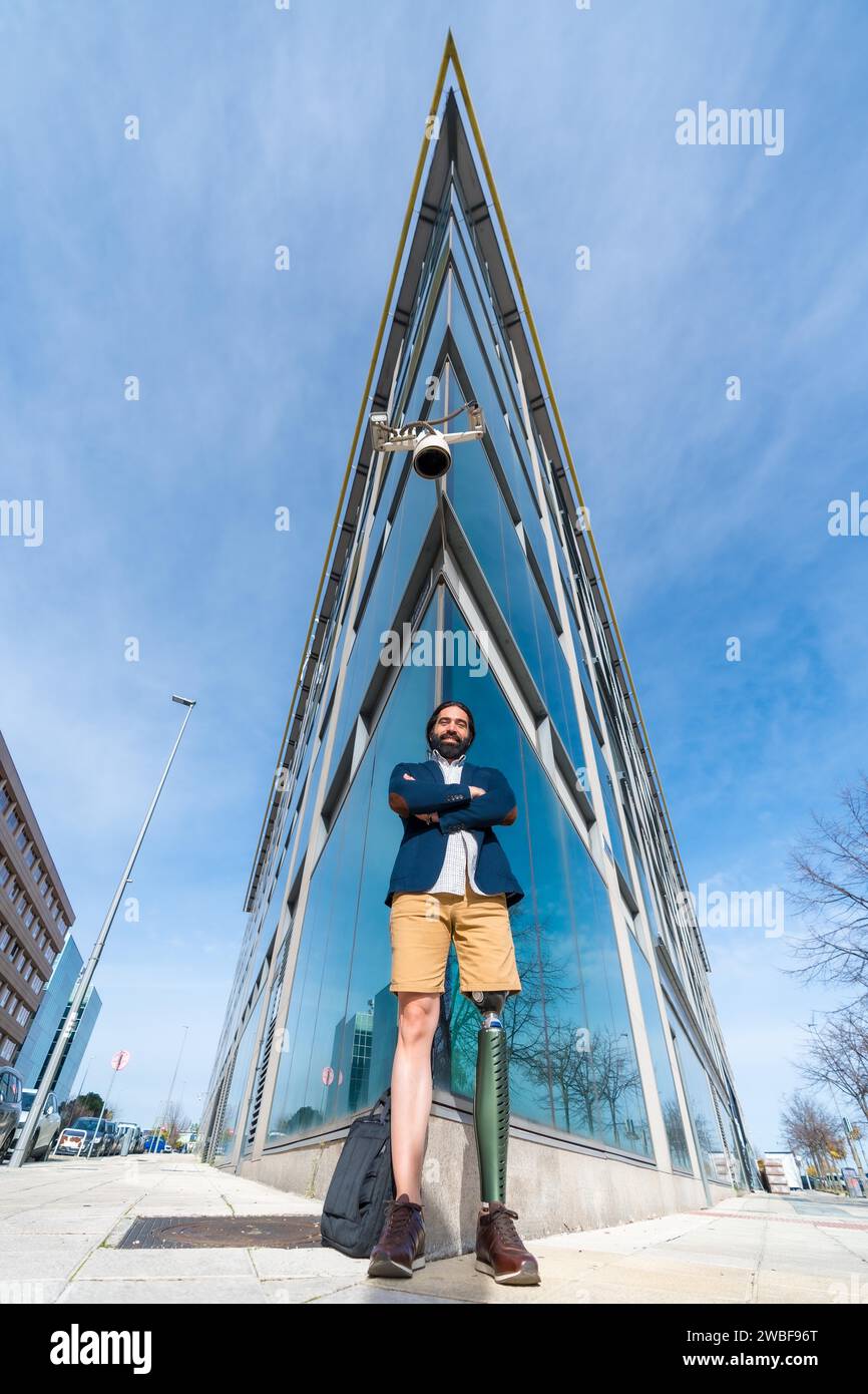Vertical portrait with low angle view of a businessman with prosthetic ...