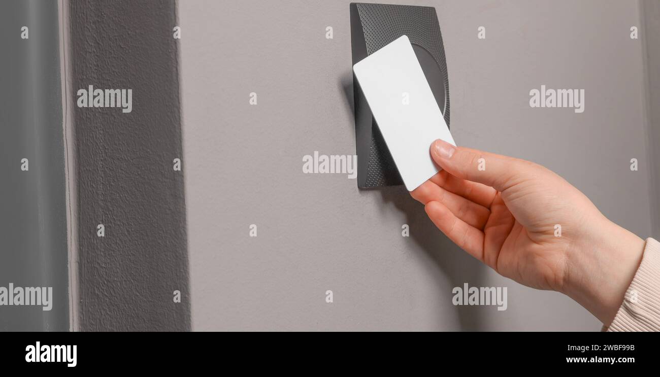 Woman opening magnetic door lock with key card, closeup and space for ...