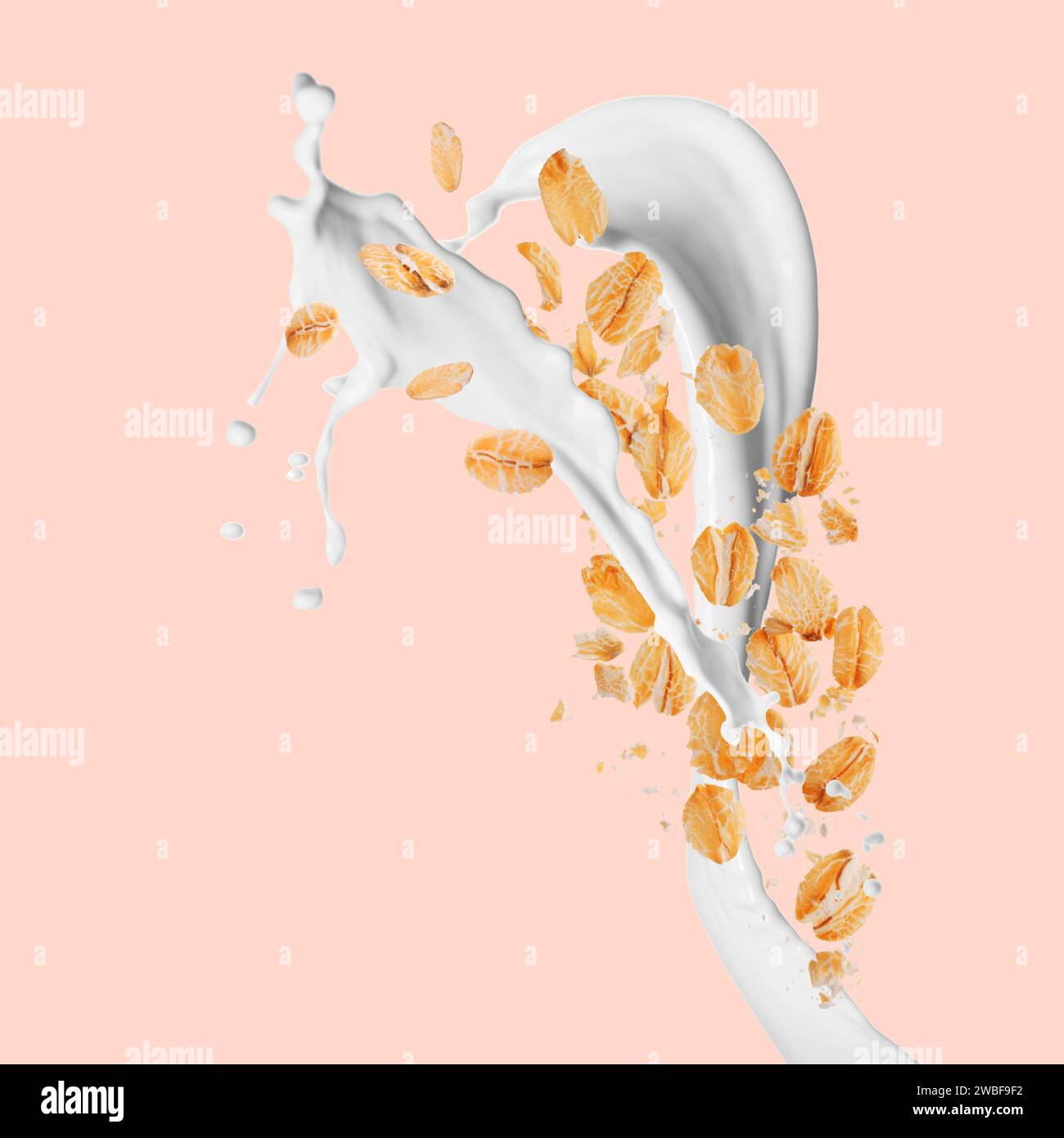 Rolled oats and milk splash on pink background Stock Photo - Alamy