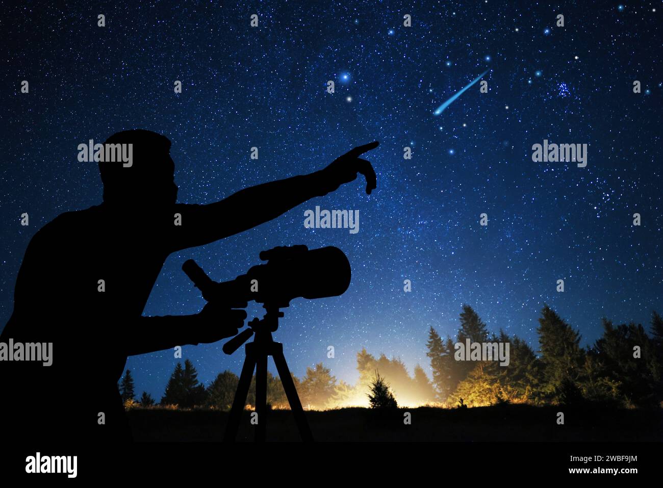 Astronomer with telescope pointing at shooting star outdoors Stock ...