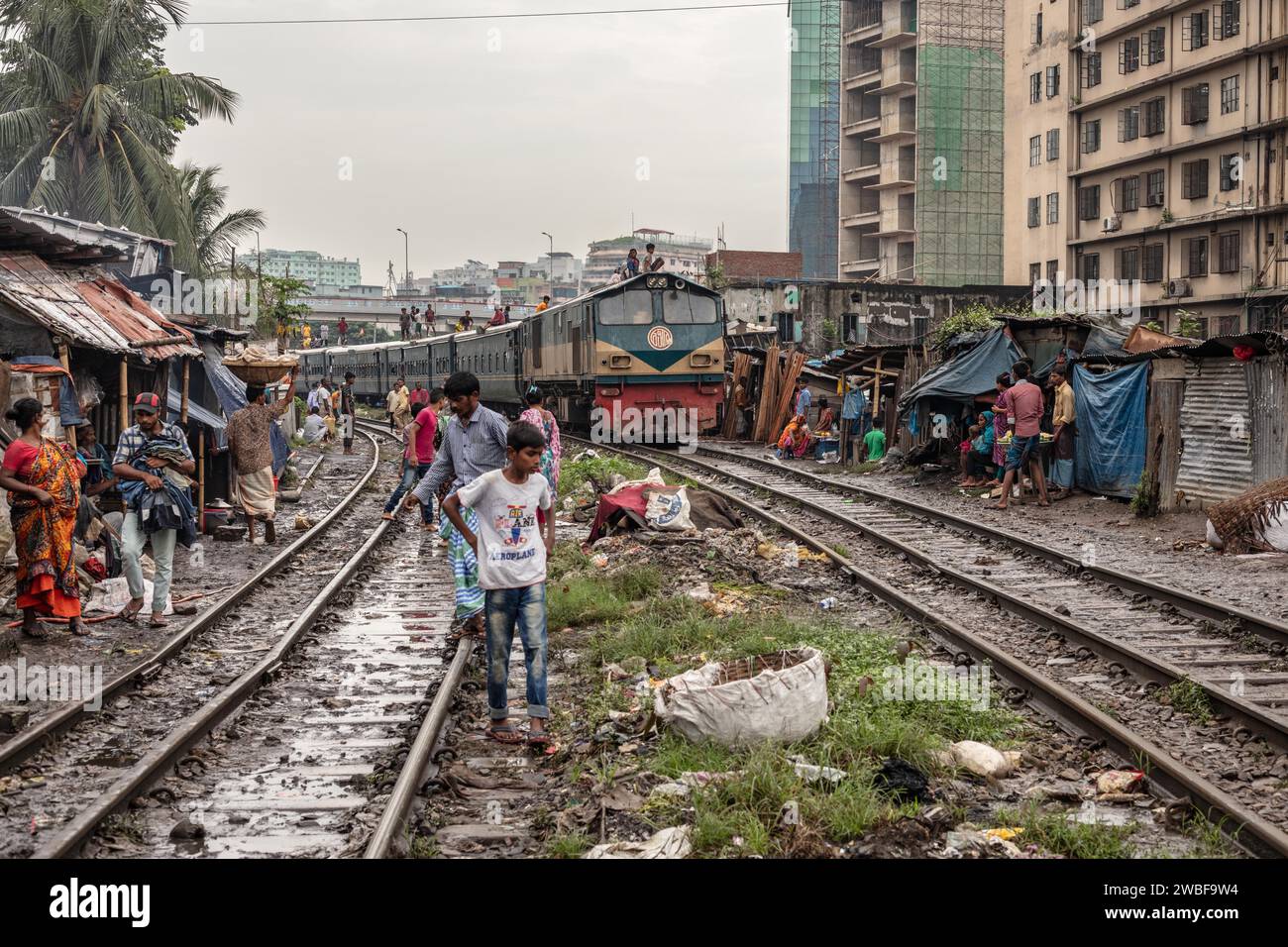 A train passes through an informal settlement built close to a railway ...