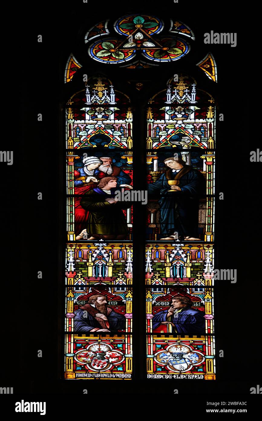 Colourful stained glass window with reformers Johannes Calvin and ...