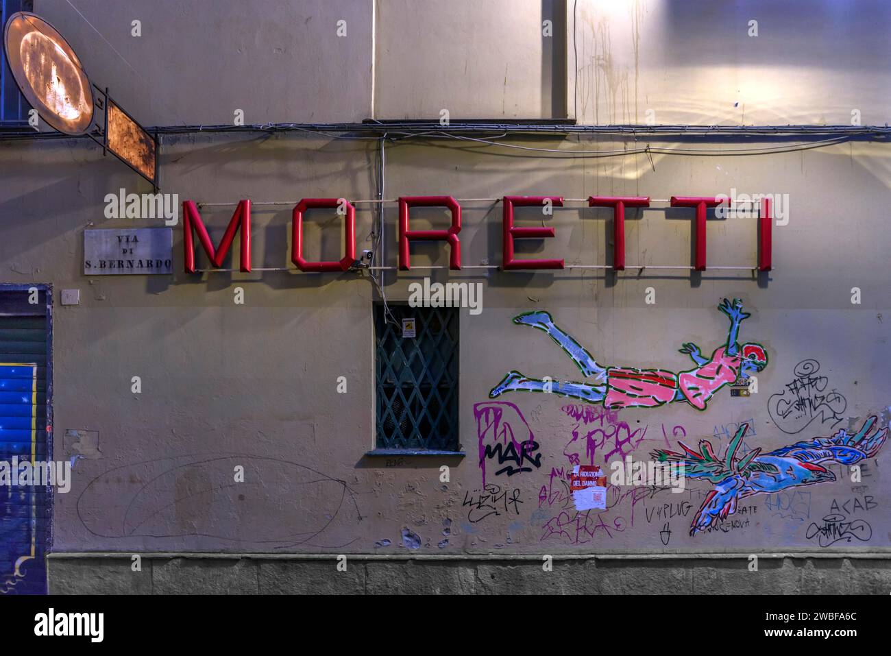 Moretti, lettering of a bar, underneath graffiti on a house wall ...