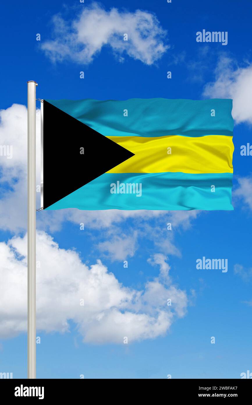 National flag of the Bahamas in front of cumulus clouds and blue sky ...