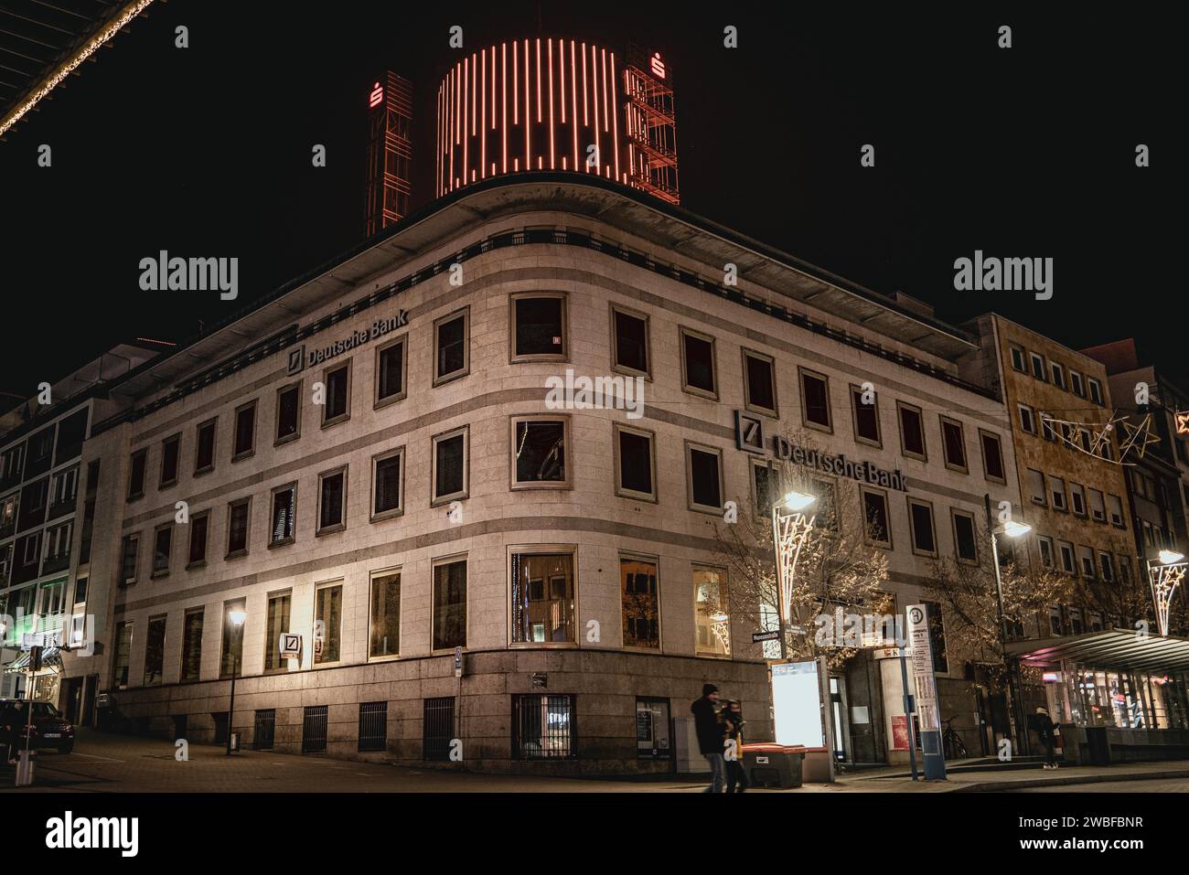 Historic bank building at night with warm street lighting in an urban ...