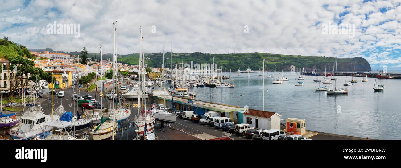 Panoramic view of a busy marina of Horta with boats and surrounded by ...
