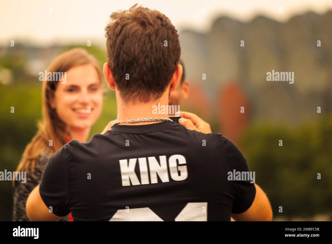 Back view of a couple, with a man wearing a T-shirt with the ...