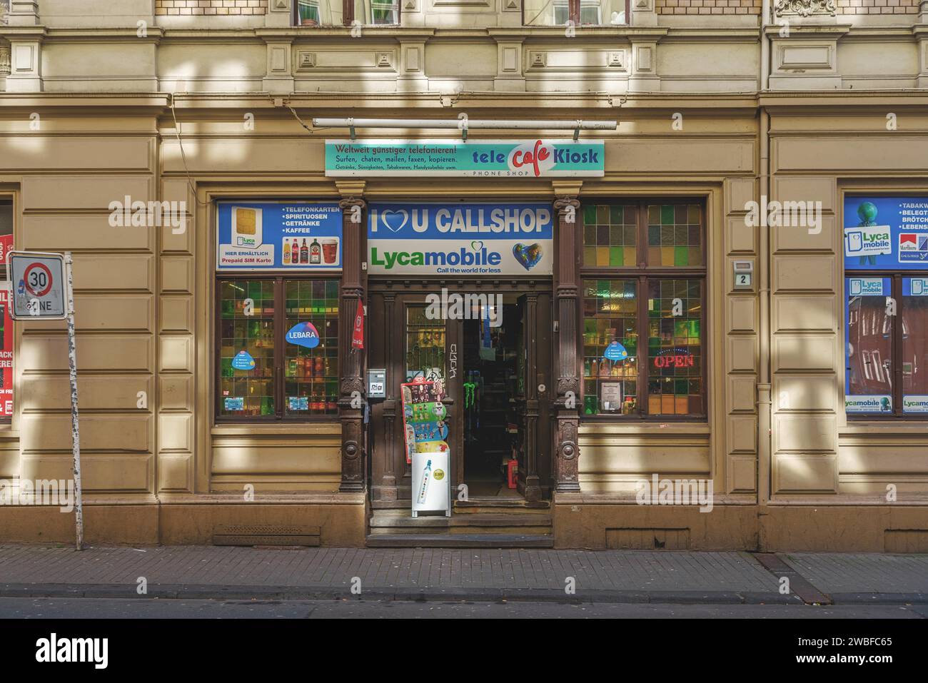 Small business with colourful advertising signs and shop window in a ...