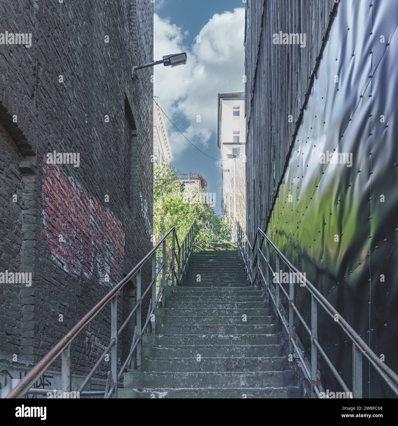 Urban scene with a staircase between two buildings and graffiti wall ...