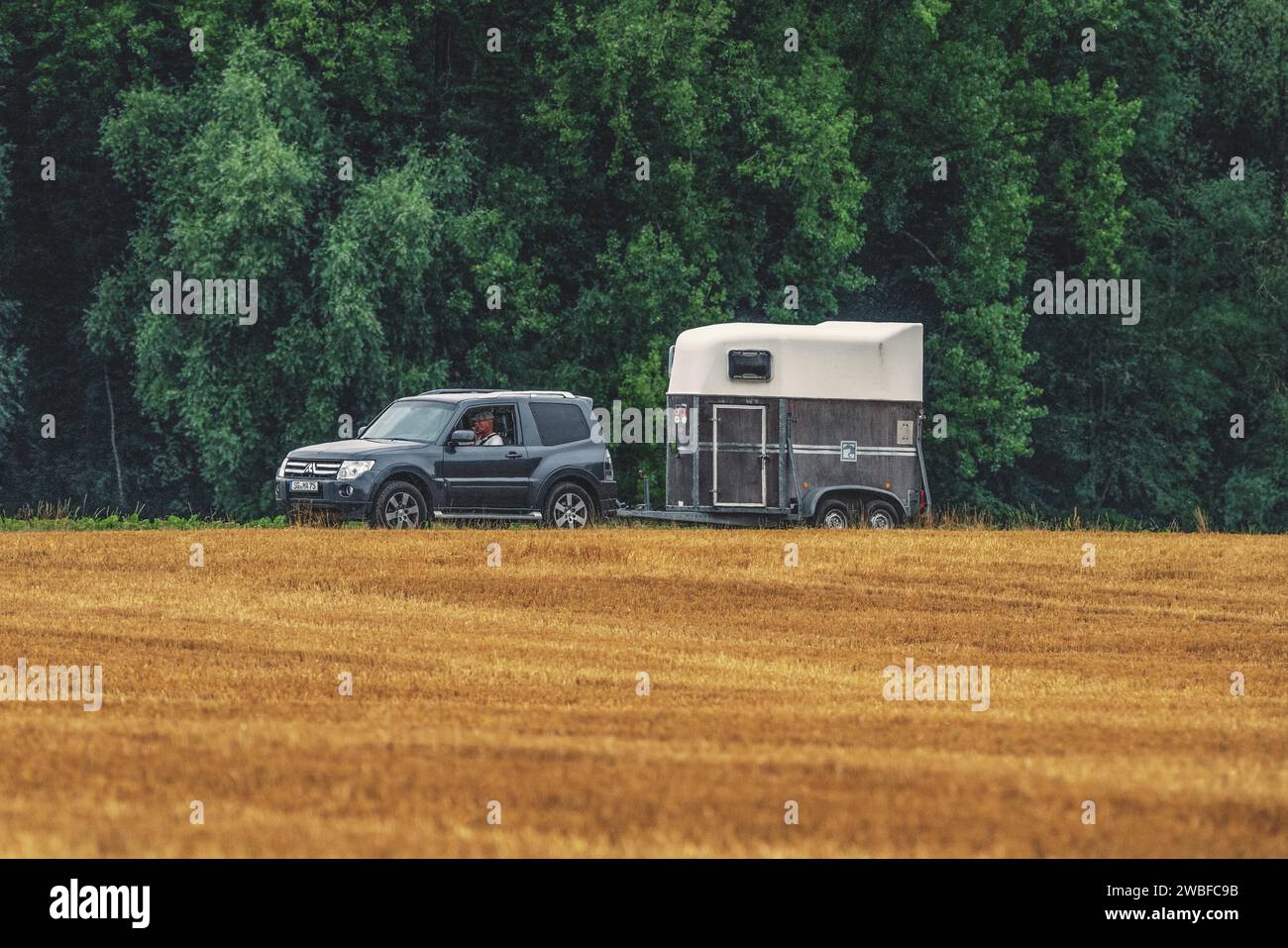 Off-road vehicle with horse trailer on an agricultural field, Osterholz ...