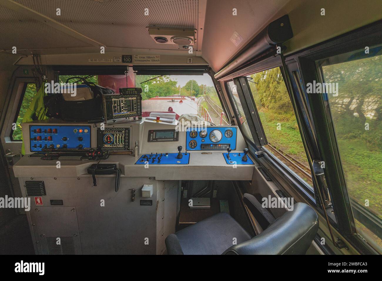 Interior view of an engine driver's cab with controls and view through ...