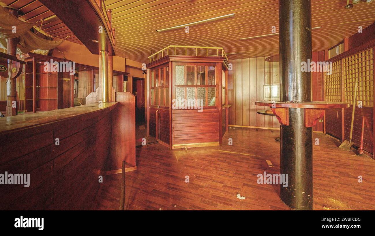 Abandoned bar with wooden counter and interior design that conveys a ...