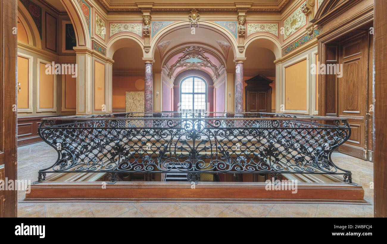 Classical architecture of an interior with ornate railings and marble ...