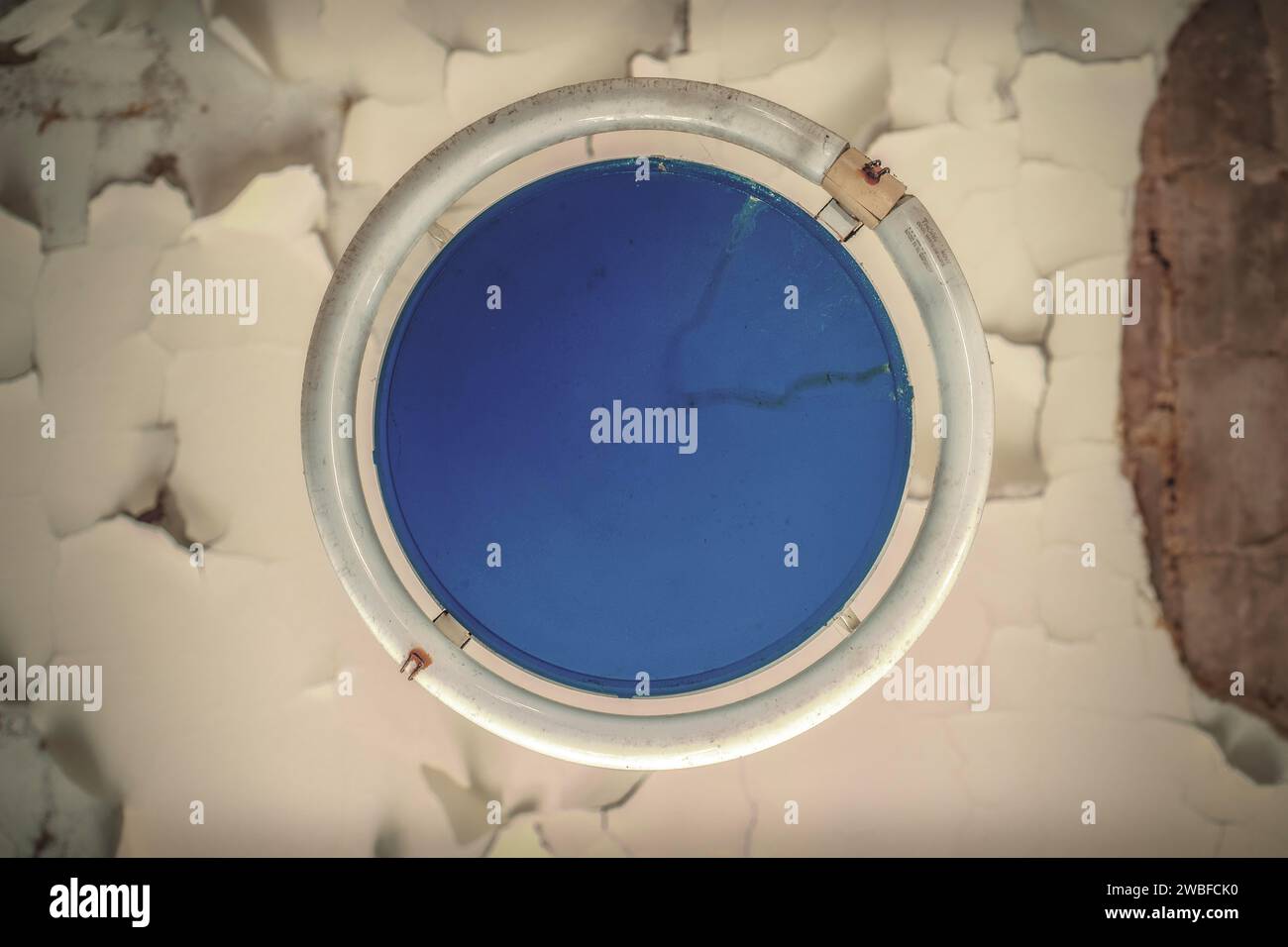 A close-up view of a round hatch window with blue eggshell texture ...