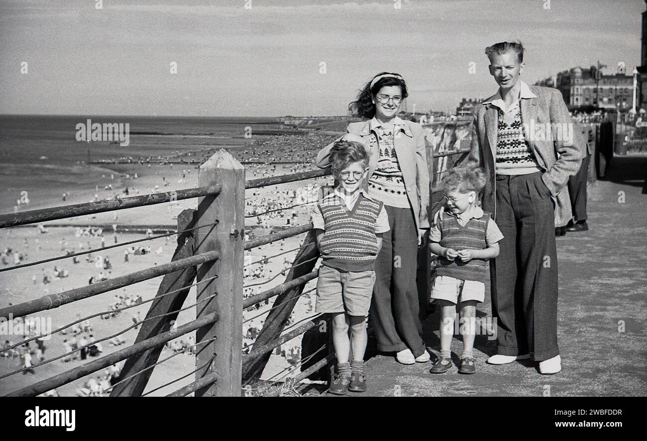 1960s, historical, family on holiday, jumpers for parents and tank tops ...