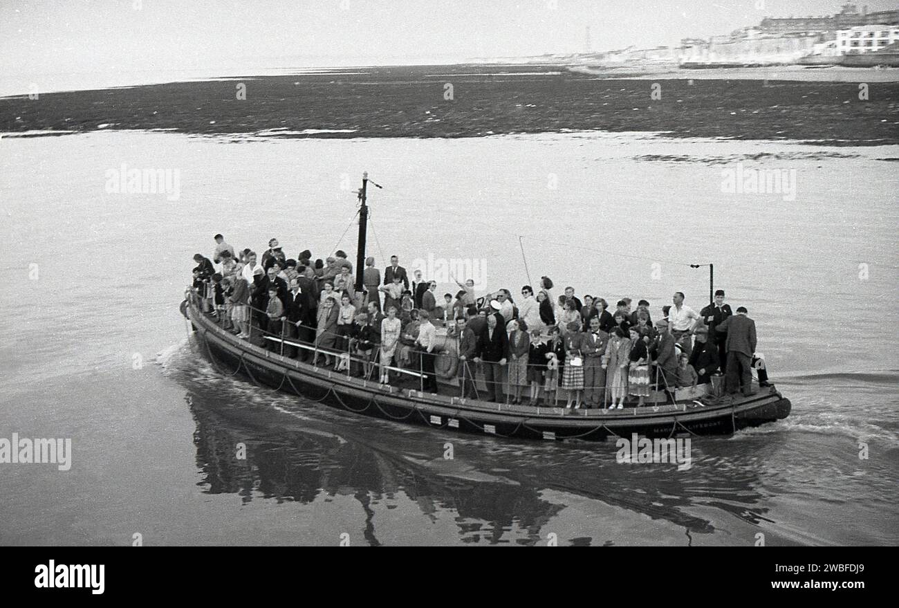1960, historical, a group of holiday makers having a ride on the ...