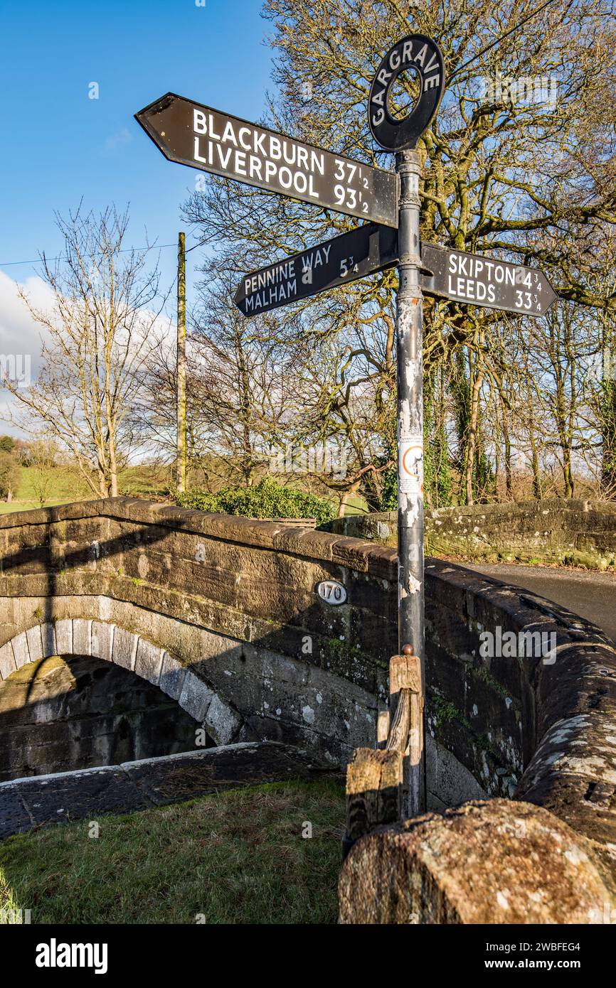 'Pennine Way' signed on a post at Gargrave alongside a bridge over the ...