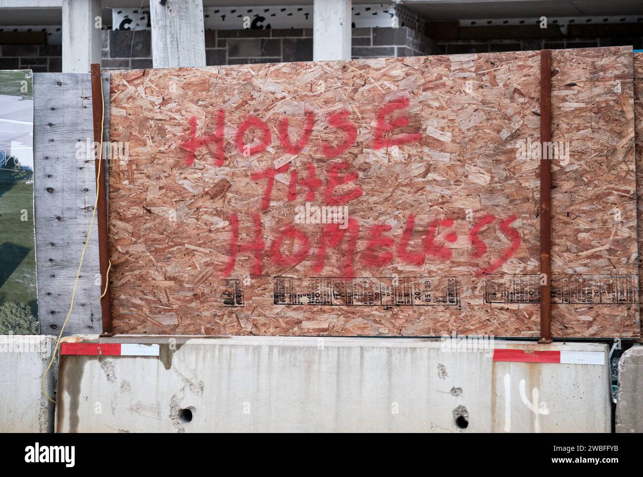 "House the Homeless" graffiti on the boarded up surrounding ...