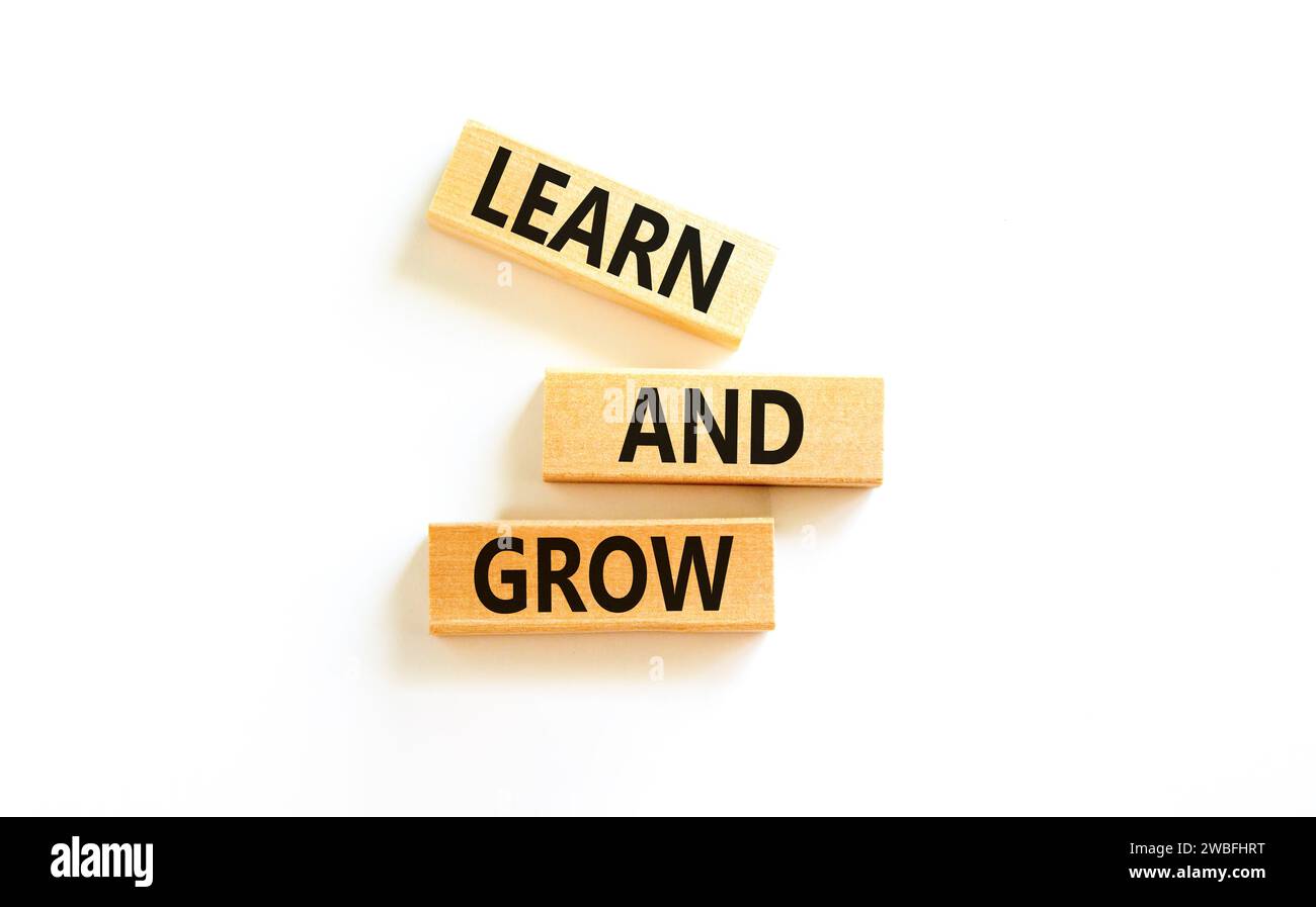 Learn and grow symbol. Concept word Learn And Grow on beautiful wooden ...