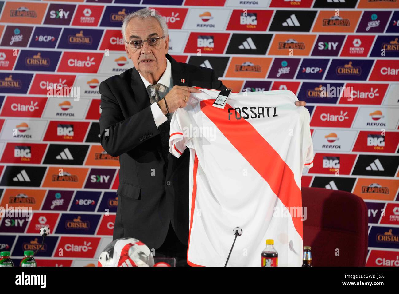 Jorge Fossati, of Uruguay, holds up a soccer jersey featuring his name ...