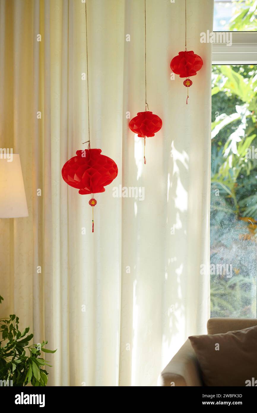 Red paper lanterns hanging in room decorated for Tet party Stock Photo ...