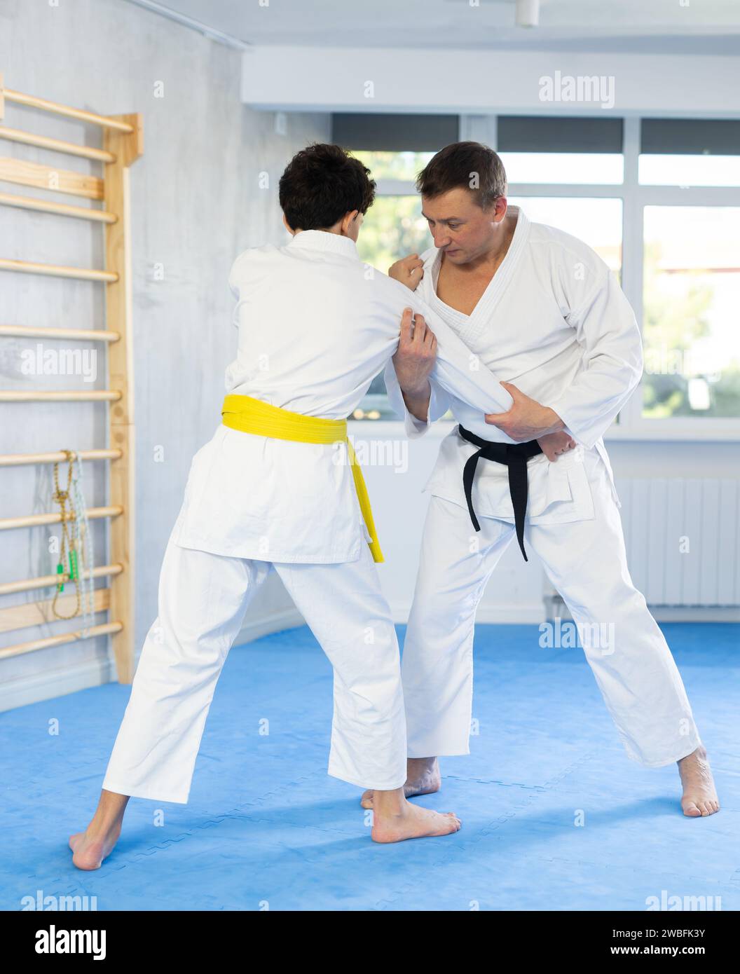 Man and teenage boy train judo fighting techniques Stock Photo - Alamy