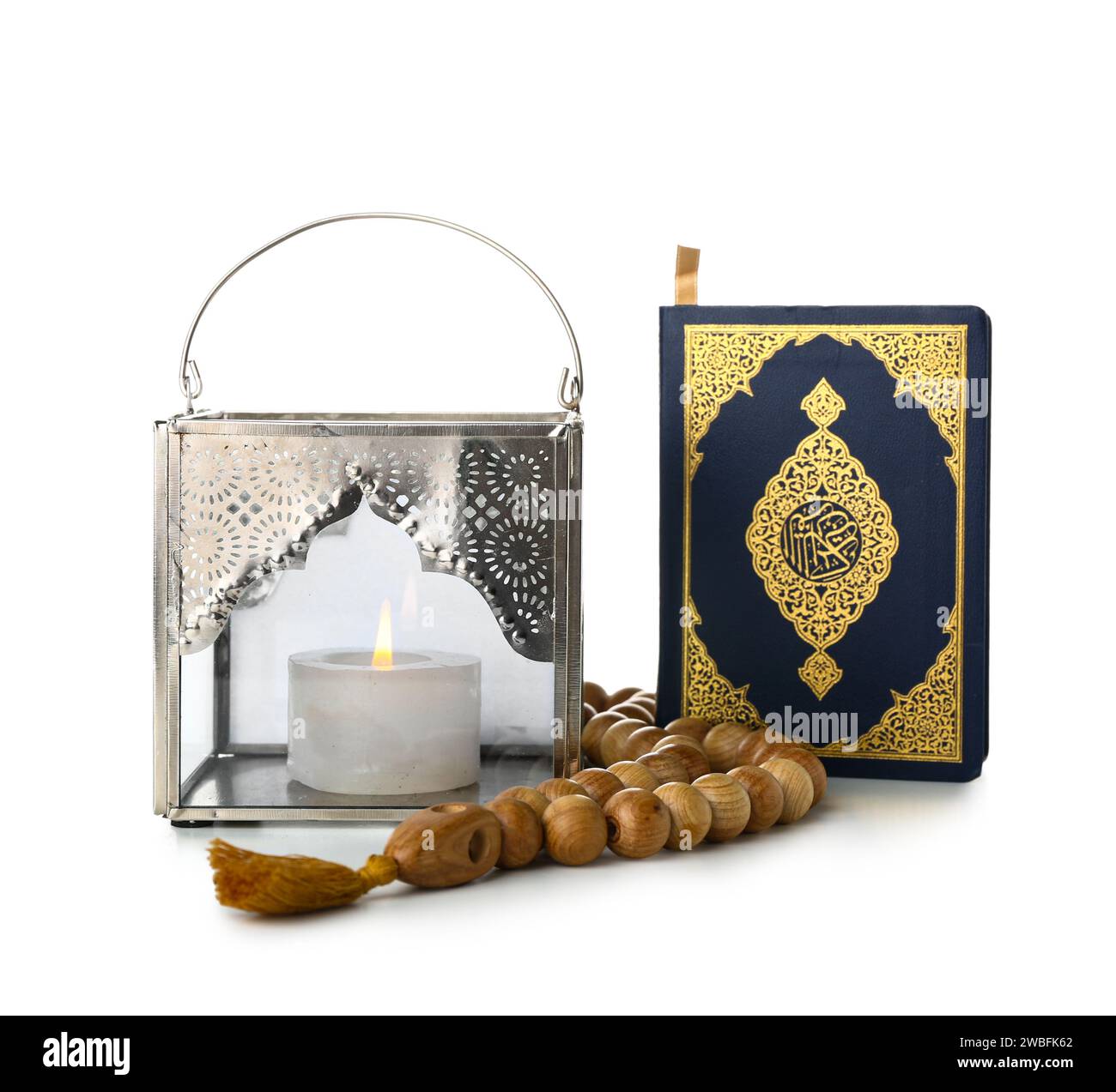 Muslim lamp with burning candle, prayer beads and Koran on white ...