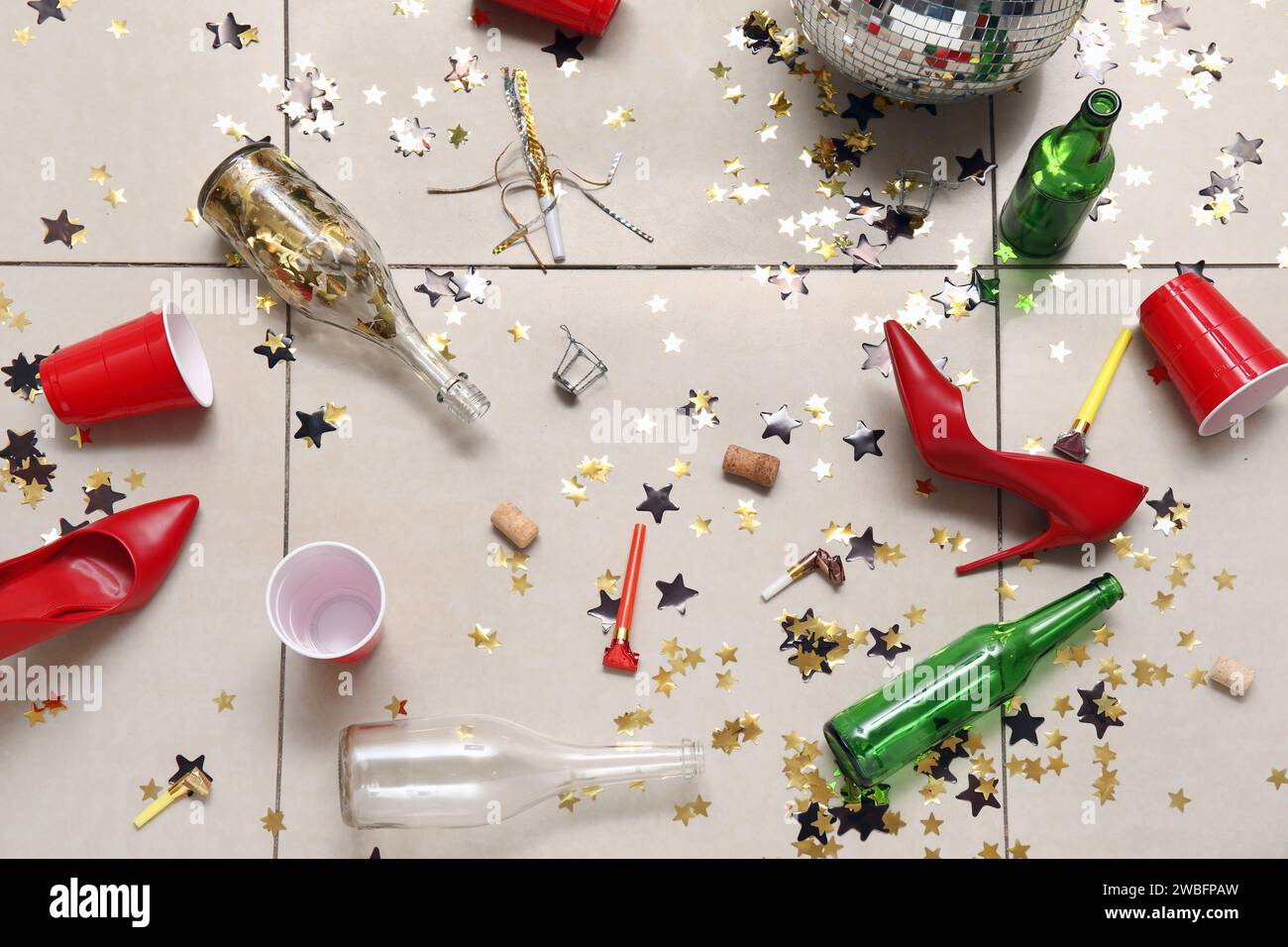 Mess with confetti on tile floor after party, top view Stock Photo - Alamy