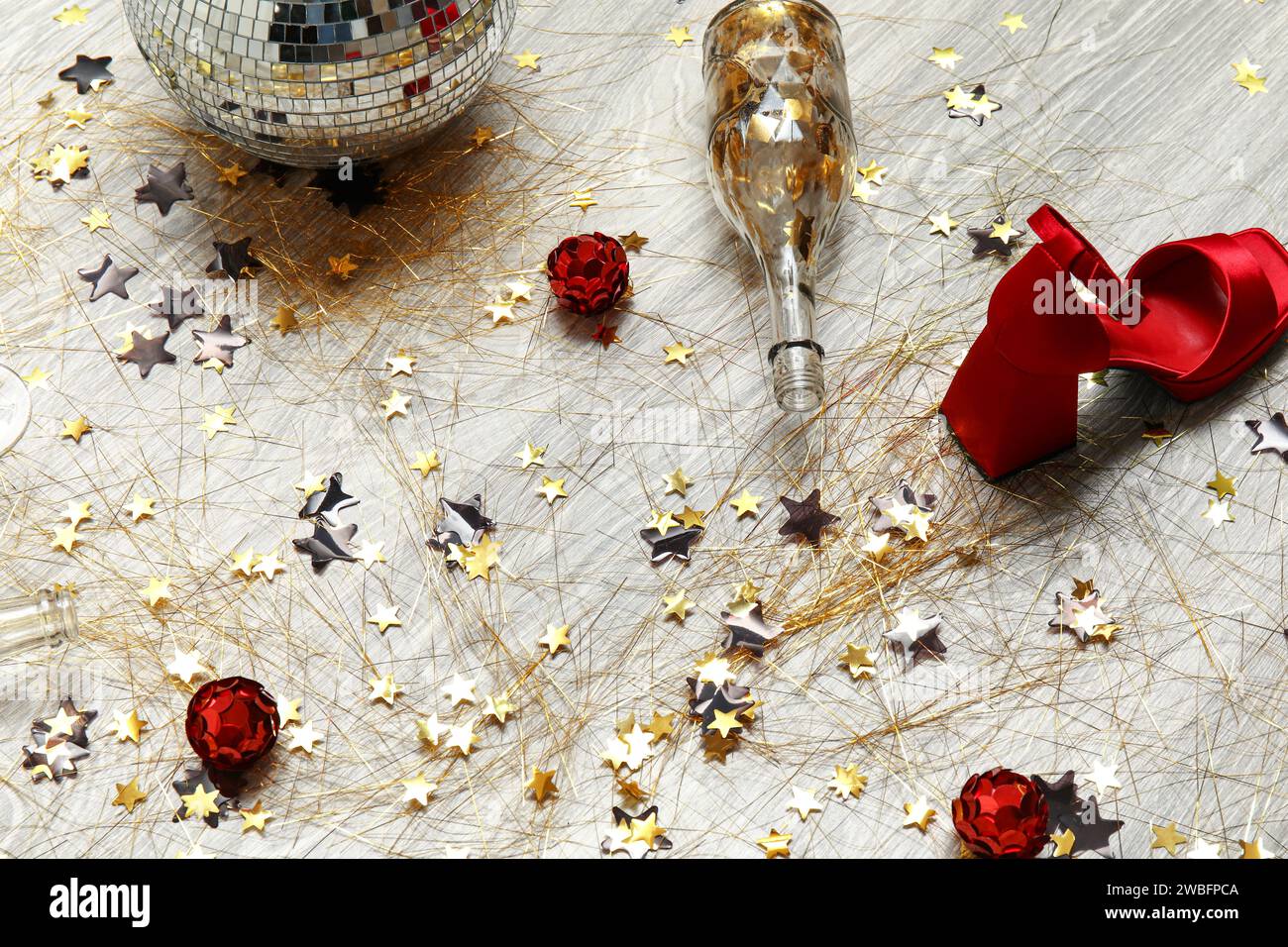 Mess with confetti on light wooden floor after party, closeup Stock ...