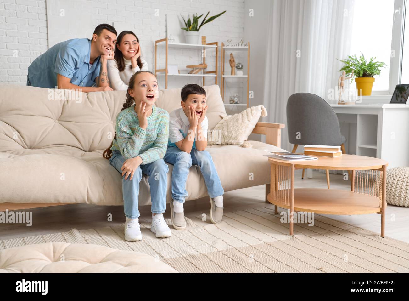 Little children with their parents watching TV at home Stock Photo - Alamy