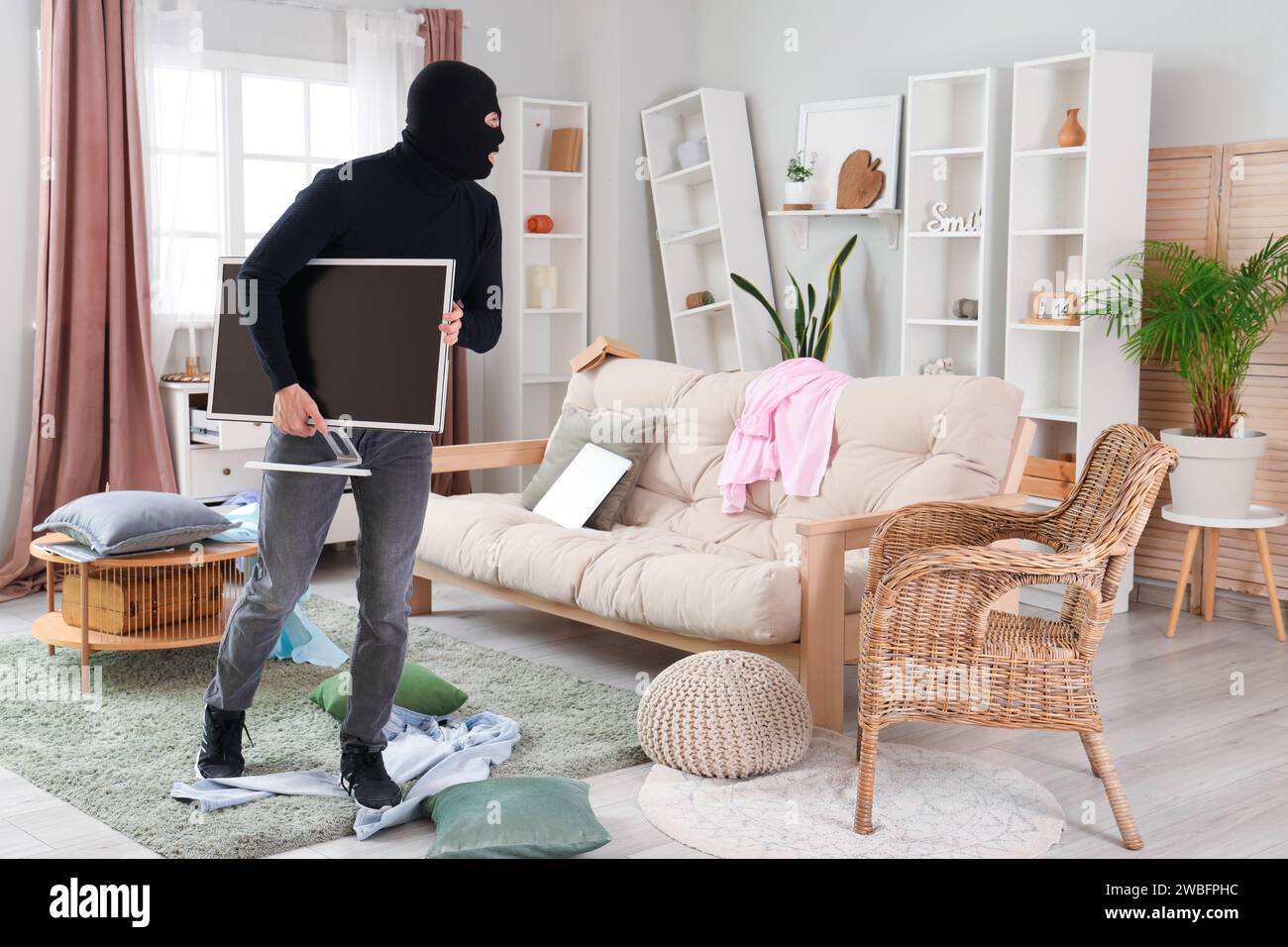 Male thief stealing monitor in room Stock Photo - Alamy