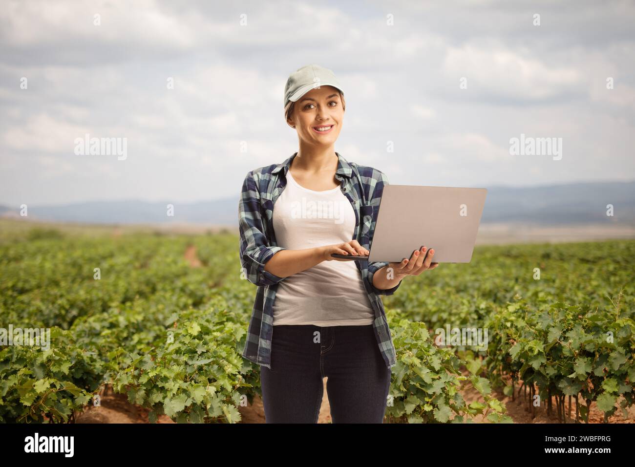 Female farmer with a laptop computer on a vineyard Stock Photo - Alamy